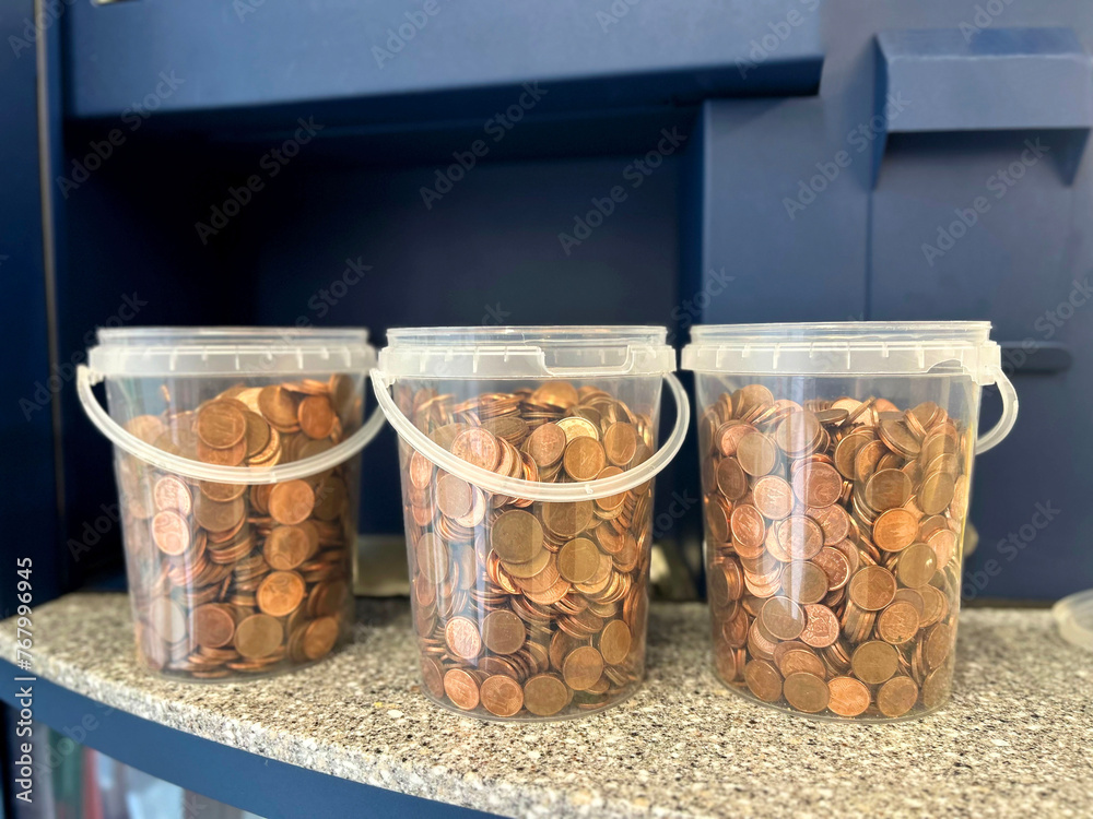 coins, small denominations, in plastic buckets for pouring into a money ...