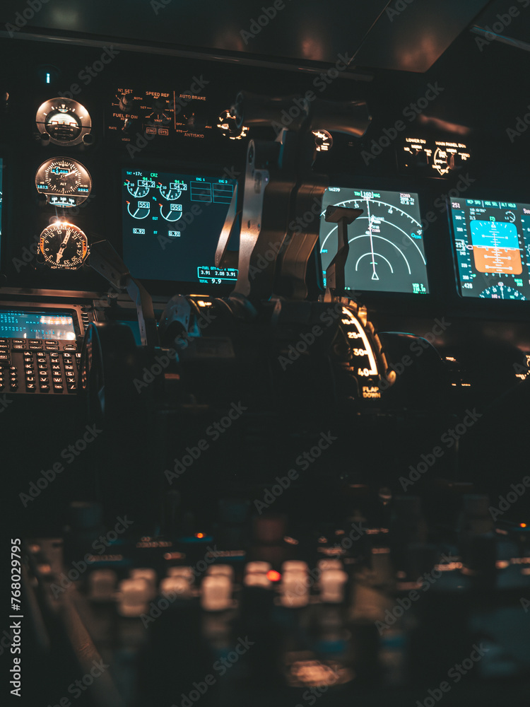 Cockpit view of an airplane during a night-time flight with illuminated ...