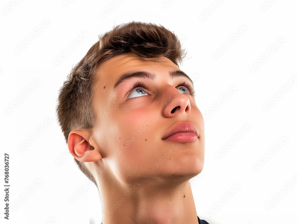Young man looking up on white background, closeup portrait of face with ...
