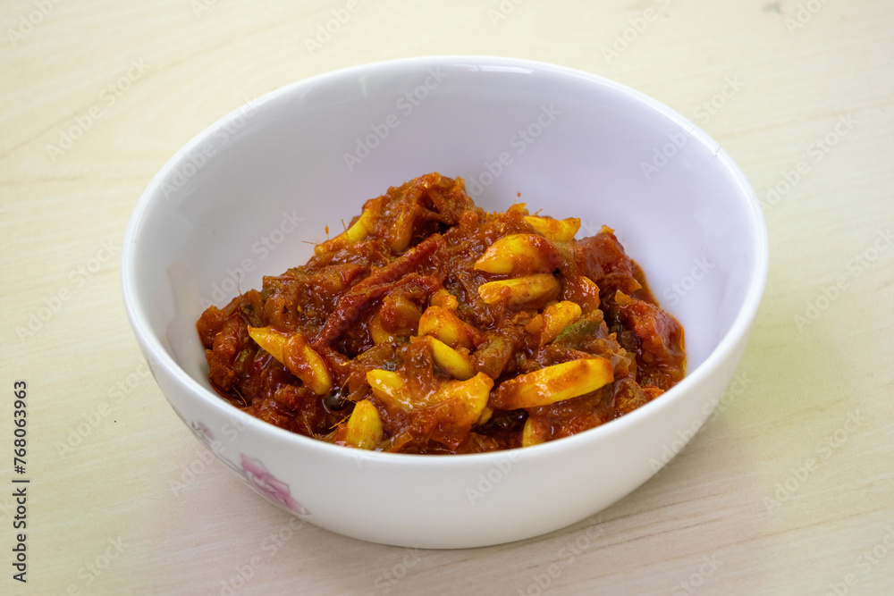 Chepa Shutki bhuna is served in a white bowl on wooden background ...