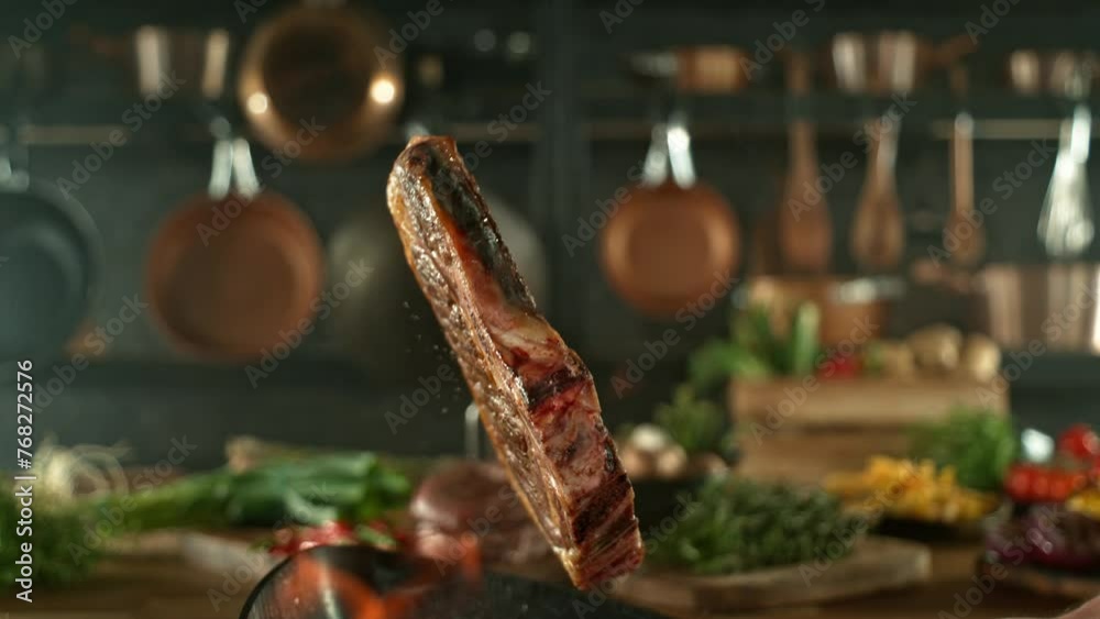 Vidéo Stock Close-up of flying and rotating tasty beef steak in kitchen ...