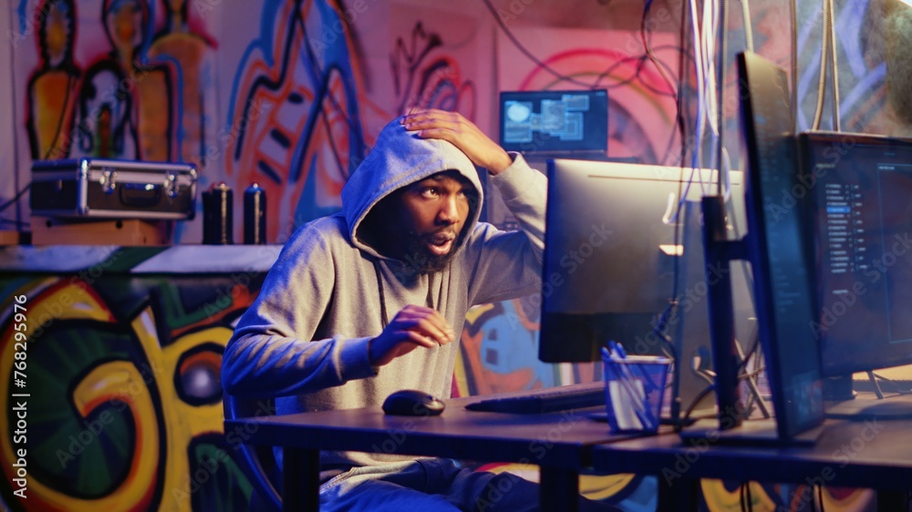 Hacker in graffiti painted hideout interrupted by police sirens from ... Hacker in graffiti painted hideout interrupted by police sirens from ...