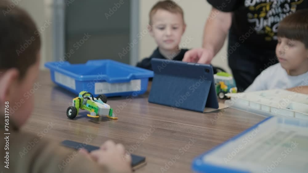 Children engage in STEM learning activities, assembling robotics kits ...