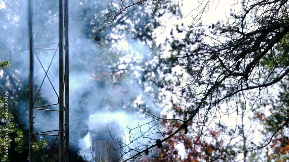 Slow motion and close up of smoke slowly rising and wafting from metal ...
