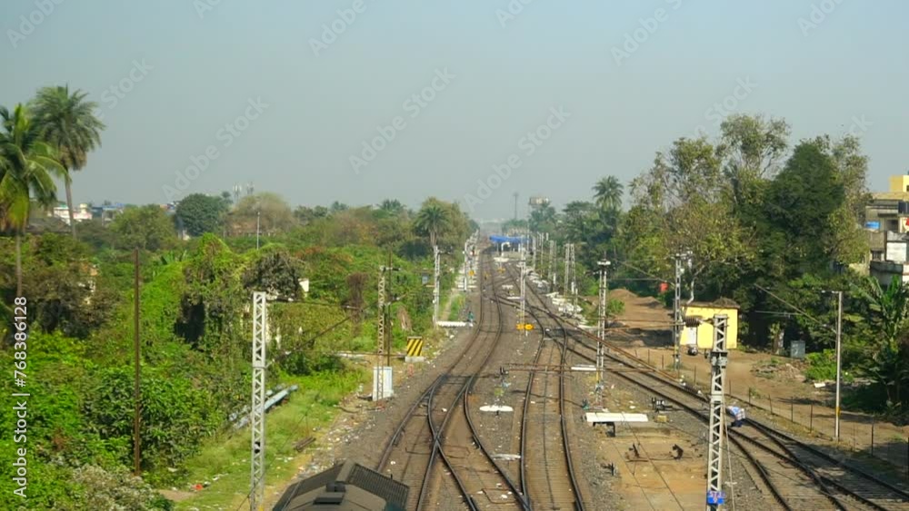 Slow motion video of passenger train passing through rail track towards ...