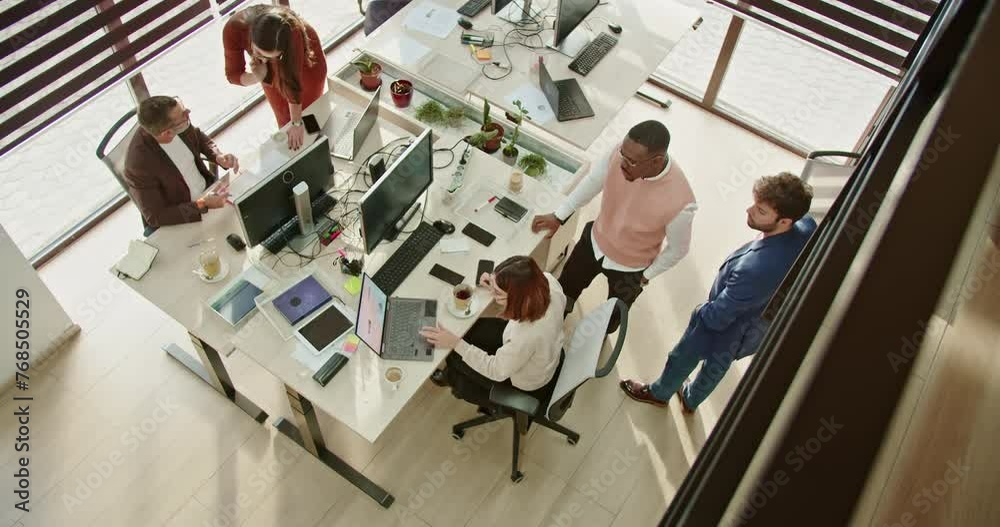 The office buzzes with energy as a top-down perspective captures ...