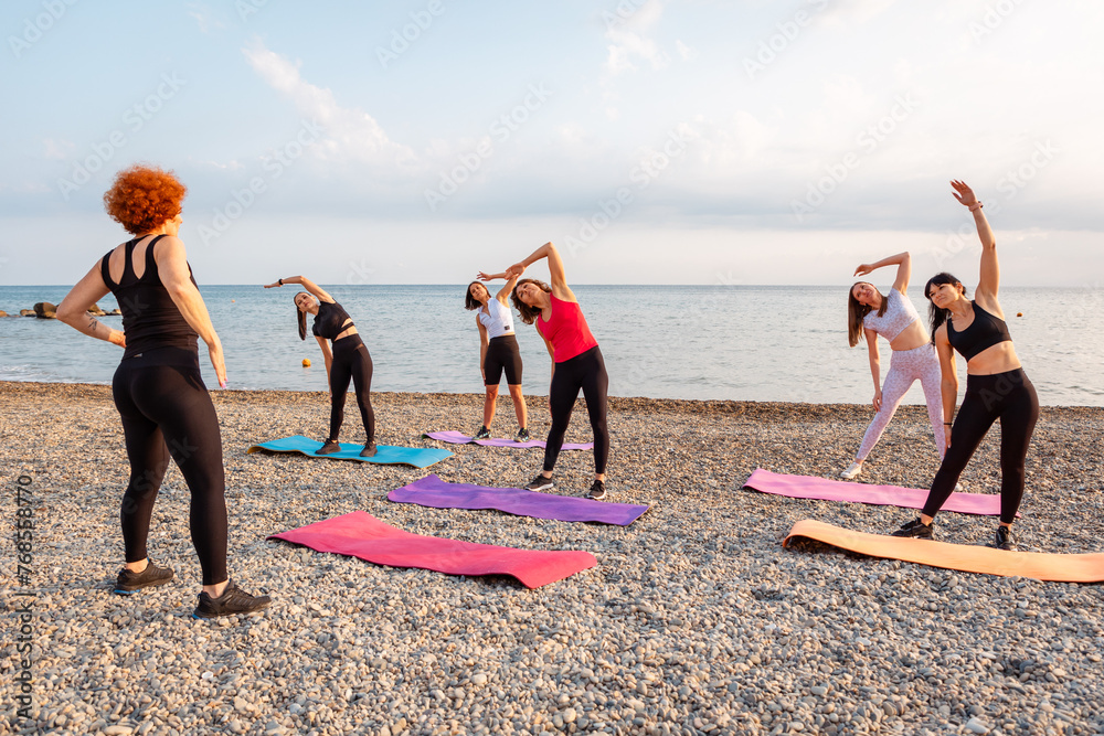 Outdoor fitness. Group of adult athletic adult Caucasian women are ...