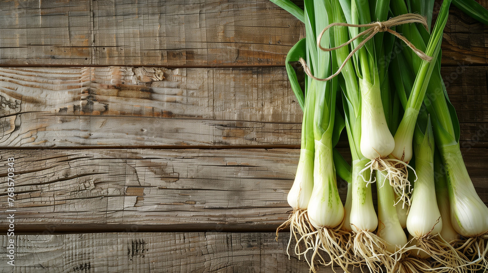 Wild leeks freshly harvested in a forest, displayed on a rustic wooden ...