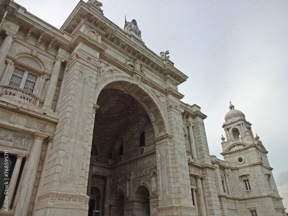 The grand Victoria Memorial Hall stands under a dramatic cloud-filled ...