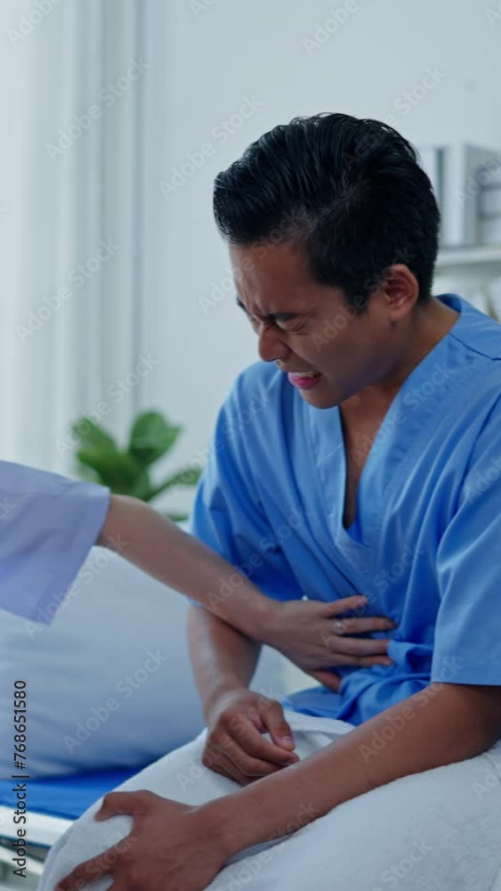 Vertical footage of Doctor examining patient stomach ache by touching ...