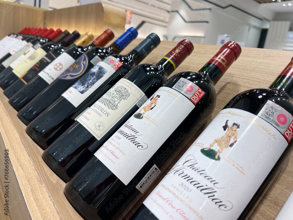 Assortment of French wine on store shelf. Official retailer of branded ...