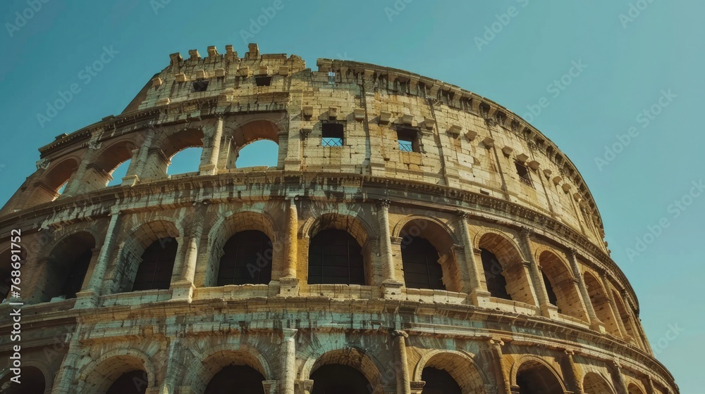 Inside and out, the Colosseum stands proud beneath a bright blue sky as ...