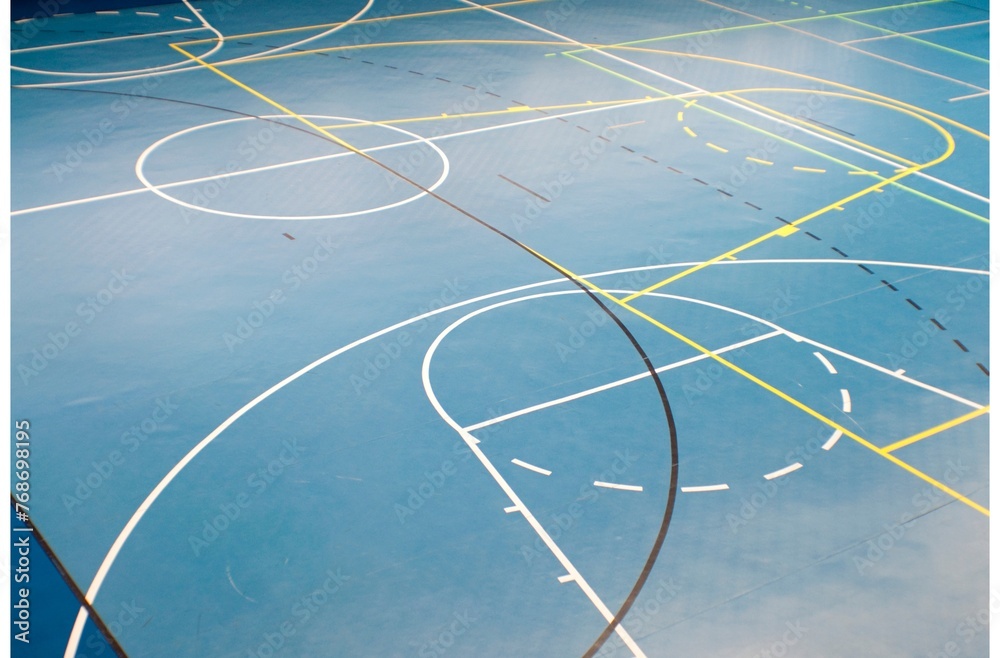 A blue rectangular basketball court with a white border and lane ...