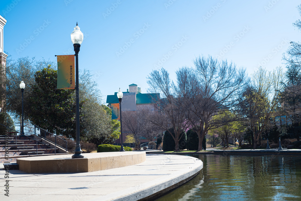 Light pole banner and buildings along Bricktown canal with curved ...
