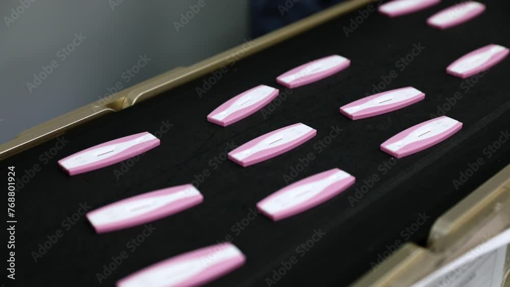 diagnostic test manufacturing line on a conveyor belt moving in a row ...