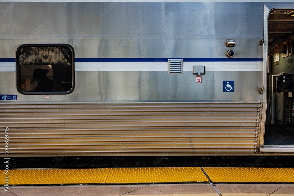 Modern train is paused at a station platform, getting ready to leave ...
