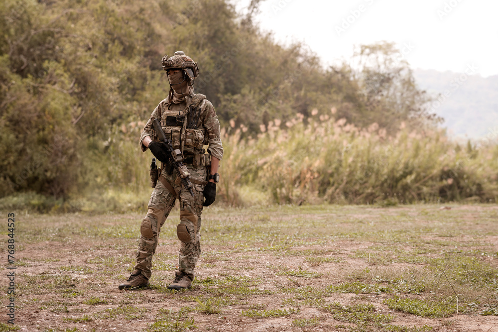 Soldiers in camouflage uniforms aiming with their rifles.ready to fire ...