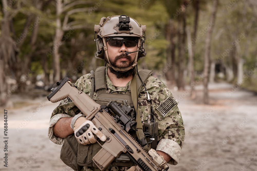 Soldiers in camouflage uniforms aiming with their rifles.ready to fire ...