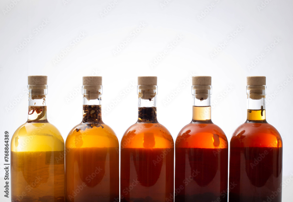 Transparent bottles with brown alcoholic drink on a white background ...