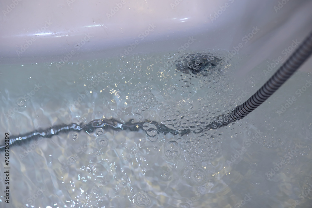 Soap bubbles background. Shampoo foam in the water in the bathroom ...