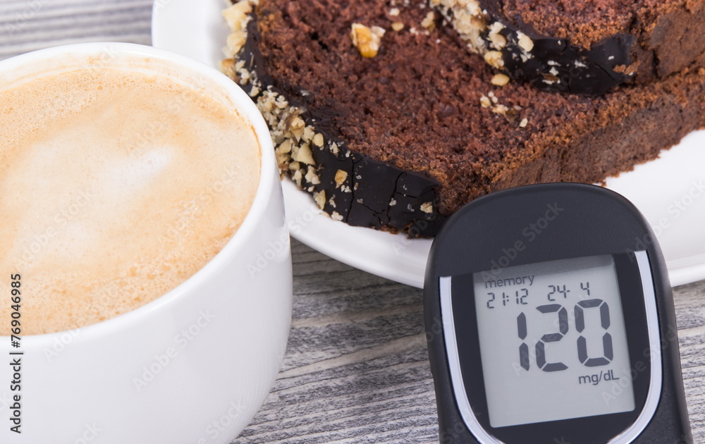 Glucose meter with high result sugar level, sweet chocolate cake and ...