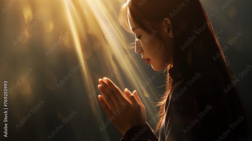 Woman praying in radiant light a spiritual moment of reflection and ...