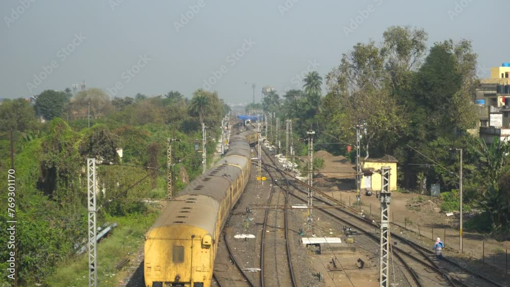 Slow motion video of passenger train passing through rail track towards ...
