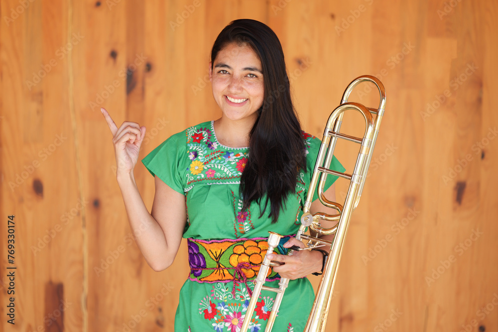 young mexican indigenous woman smiling and pointing in traditional ...