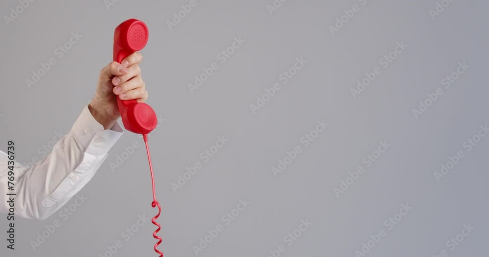 Man gets the phone, holds it for some time, then puts it down. Crop ...