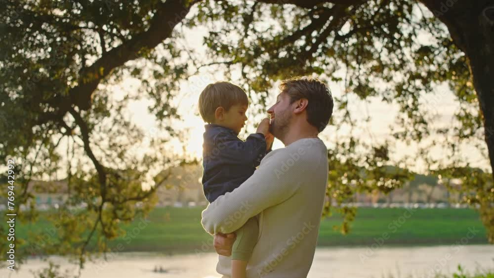 Dad and Son Enjoy a Day Together in a Park at Sunset. Romantic moment ...