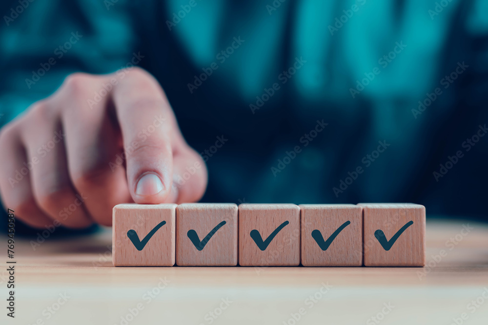 Wooden blocks display checkmarks to summarize task details and compile ...