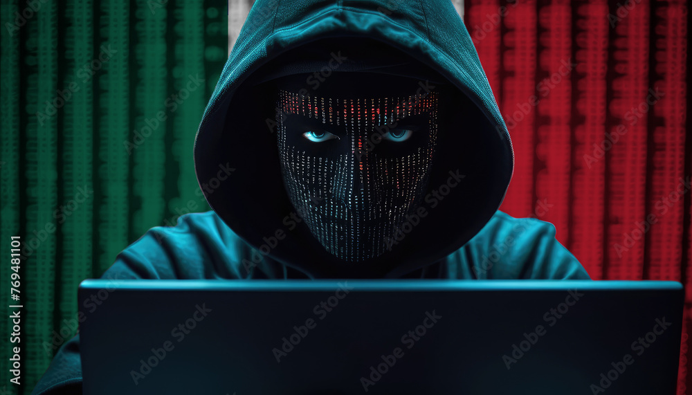 Hacker in hoodie sitting in front of a monitors with Mexico flag ...