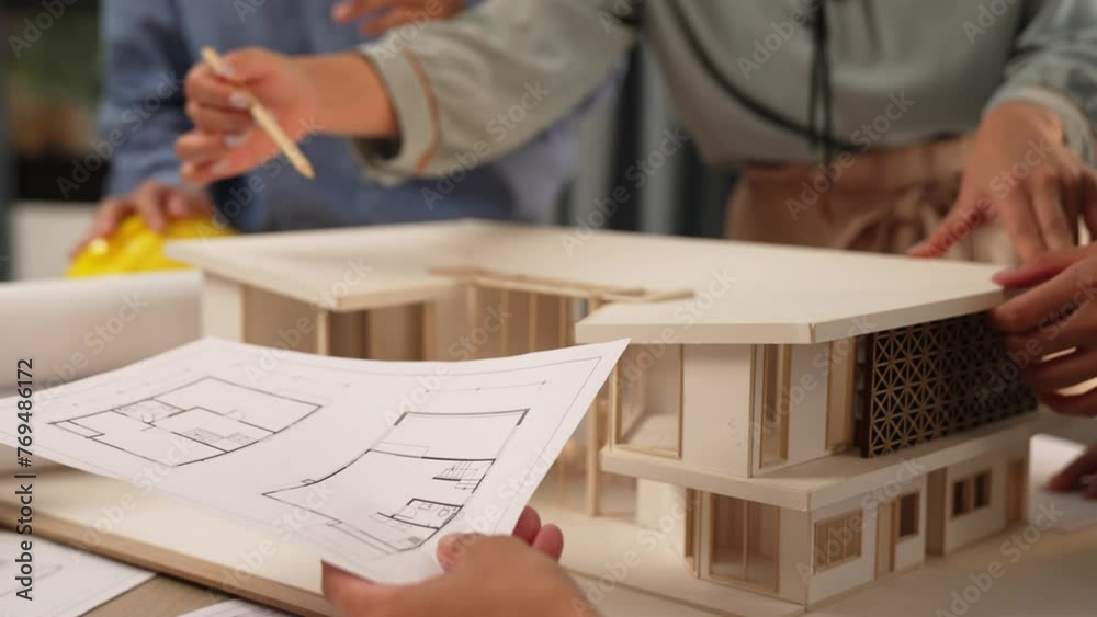 Interior designer drafting blueprint with customer supervise and ...