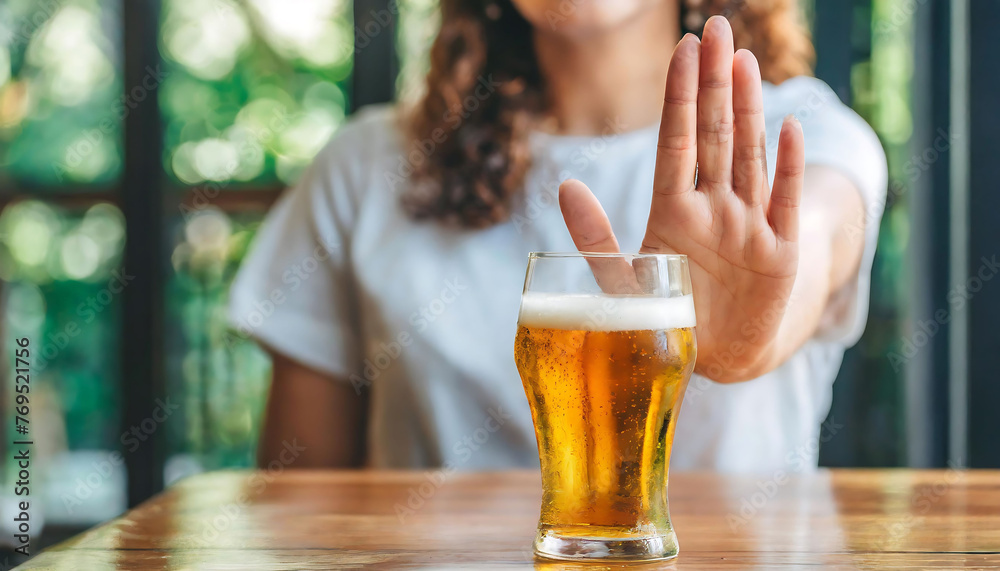The woman refuses alcohol by making a stop sign for the beer with her ...