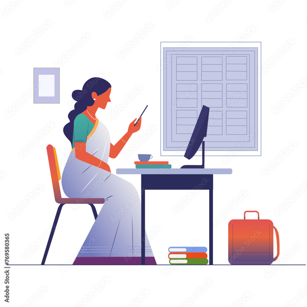 South Indian School Teacher wearing a sari sitting and working on a ...