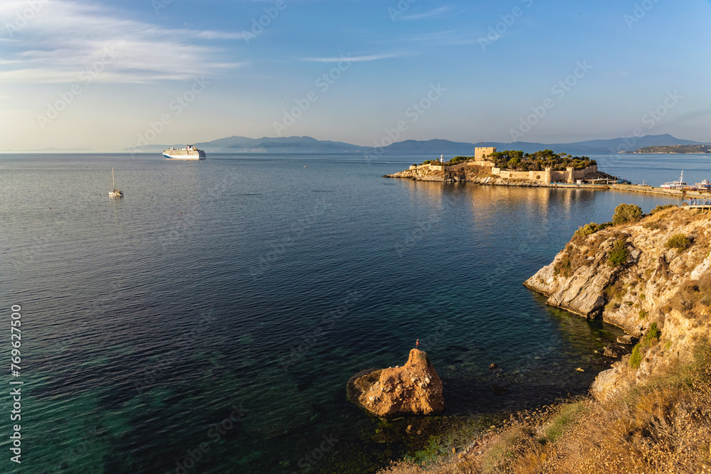Cruise ship near ancient fortress in Kusadasi bay, warm light bathing ...
