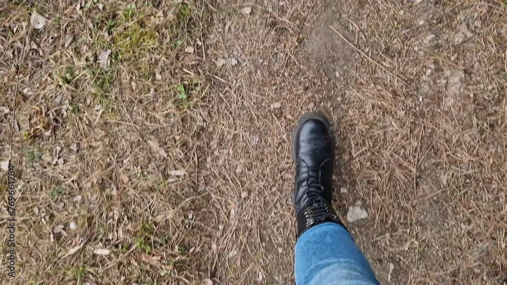 Female legs in blue jeans walk along a forest path, first-person view ...