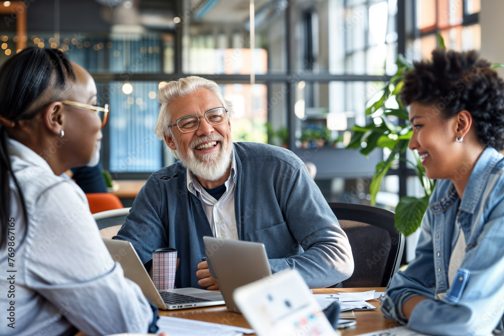 Senior mentors advising younger employees Stock Photo | Adobe Stock