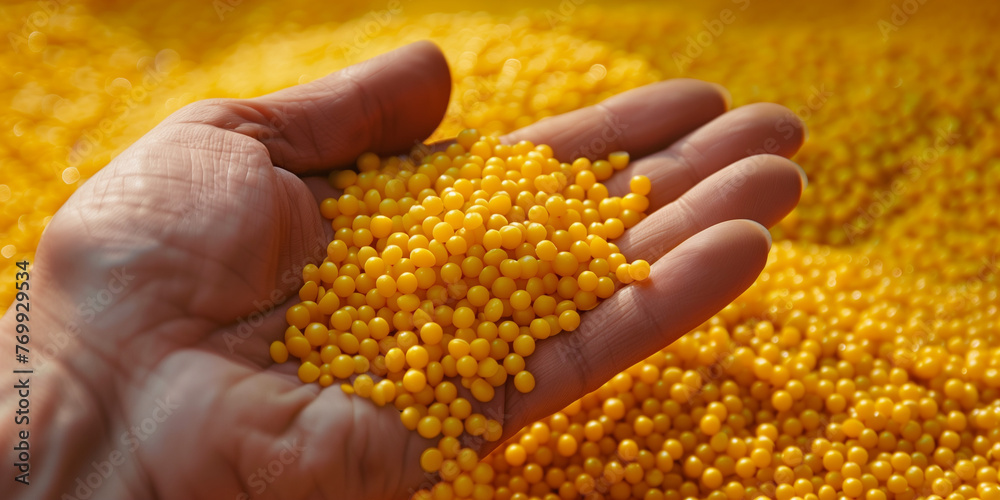 Hand Holding Yellow Plastic Resin Pellets for Plastic Manufacturing ...