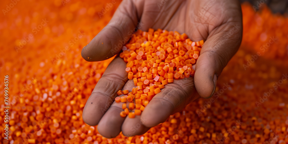 Hand Holding Orange Plastic Resin Pellets for Plastic Manufacturing ...