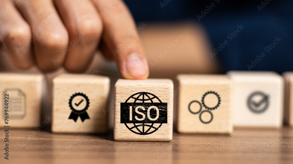 Businessman place the wooden cubes with ISO standards quality control ...
