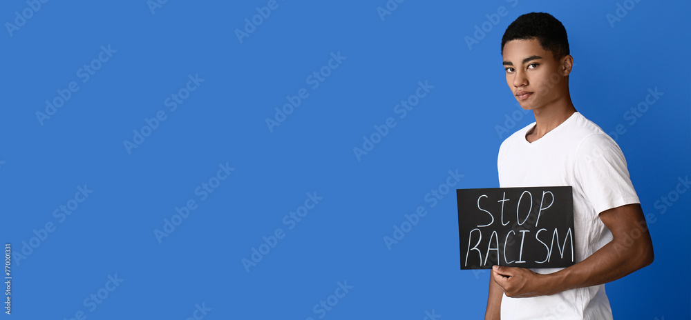 Sad African-American teenage boy with poster on color background. Stop ...