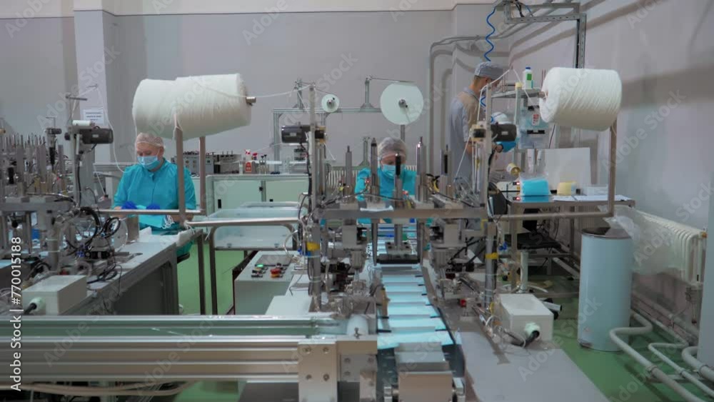 Surgical masks production at the medical facility. Workers collecting ...