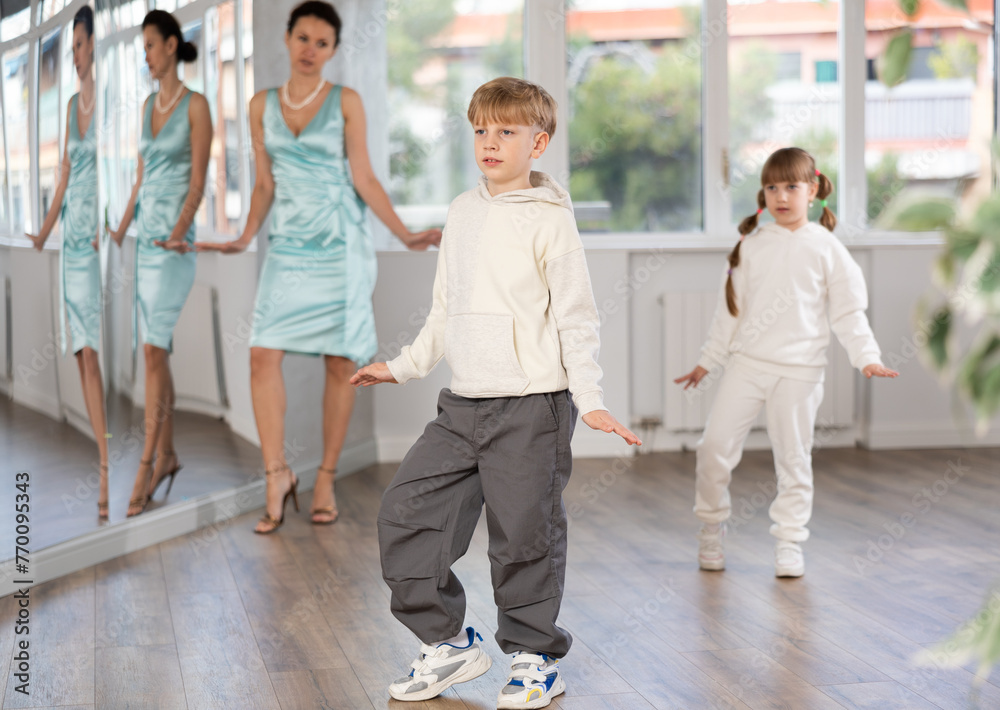 Boy and girl kids repeat movement while taking boogie woogie dancing ...