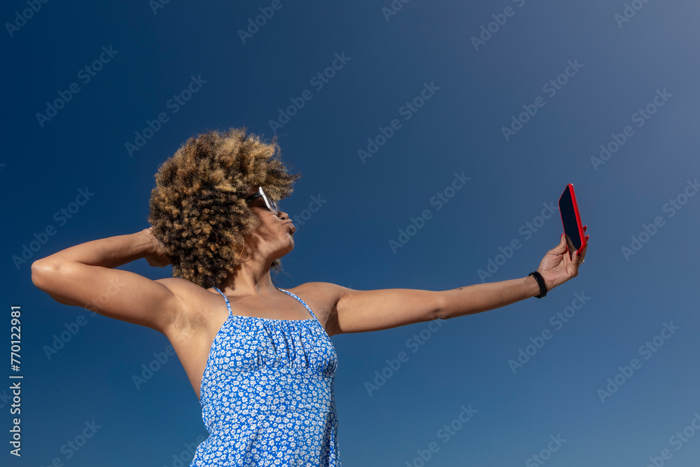 From Below Of Black Woman Captures A Selfie Moment With A Smartphone On