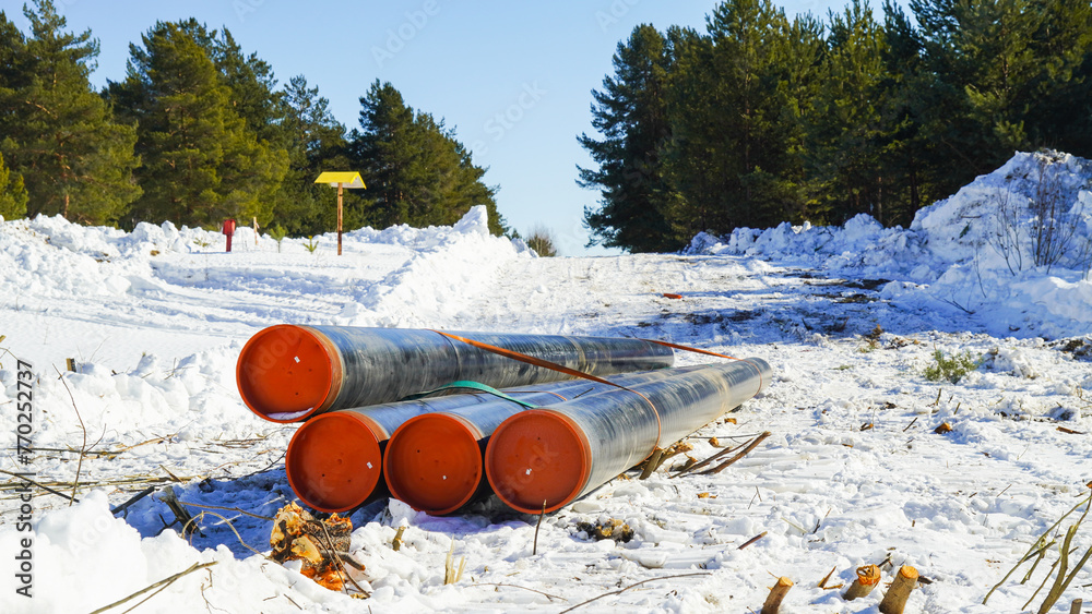 Laying of a new gas pipeline line in winter. Large diameter gas pipes ...