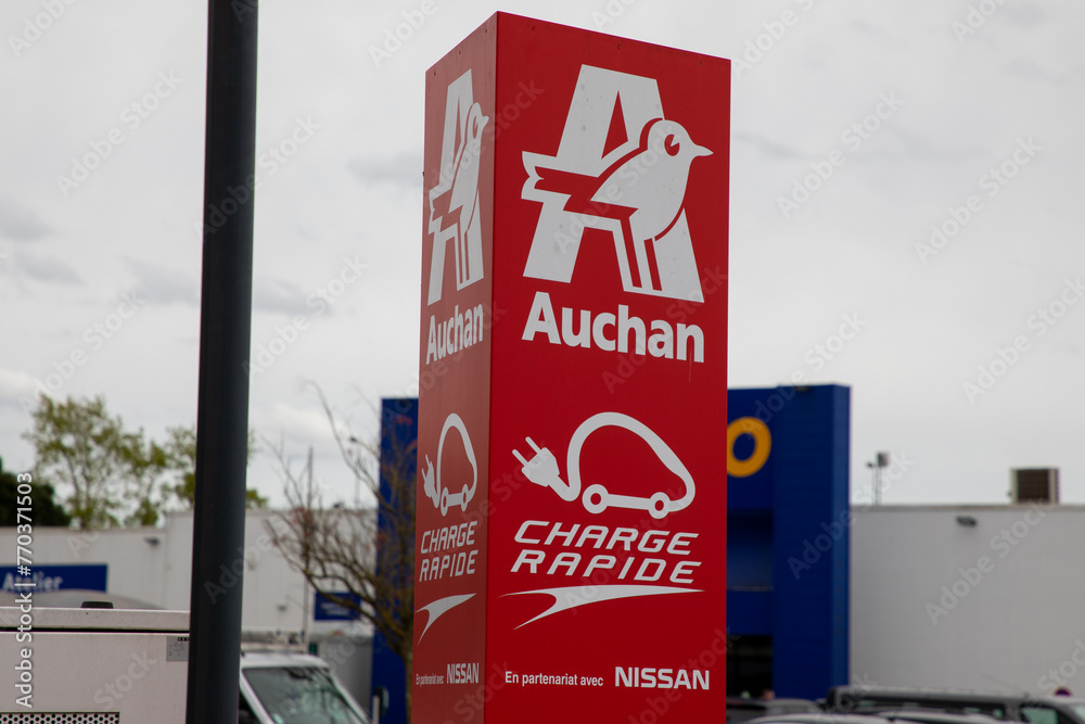 Auchan born electric logo brand of French retailer sign text on ...