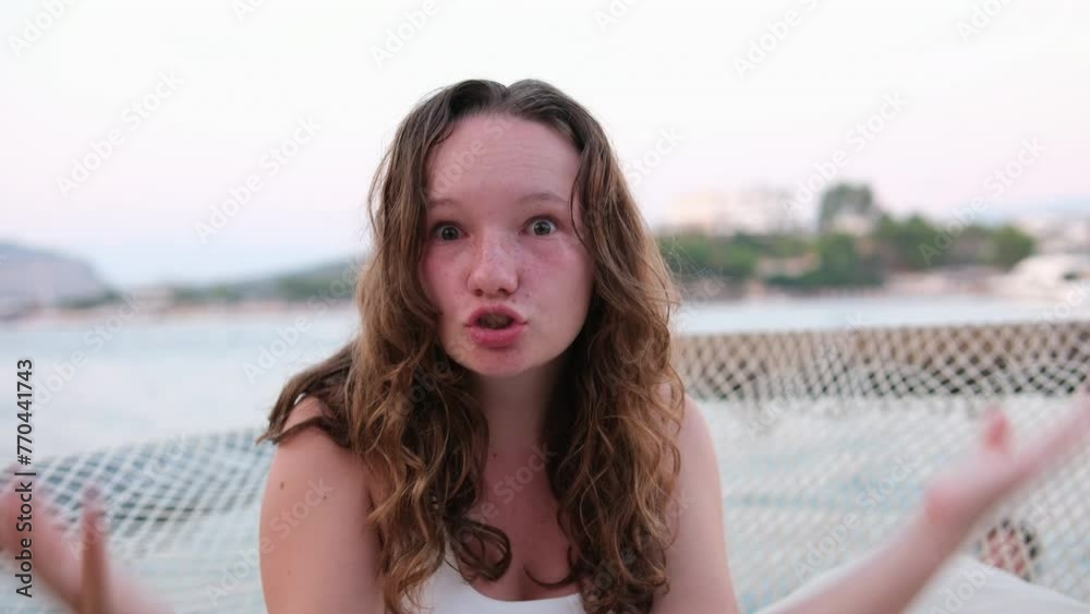 Relaxing on beach emotions of young girl burnt skin red cheeks wet hair ...
