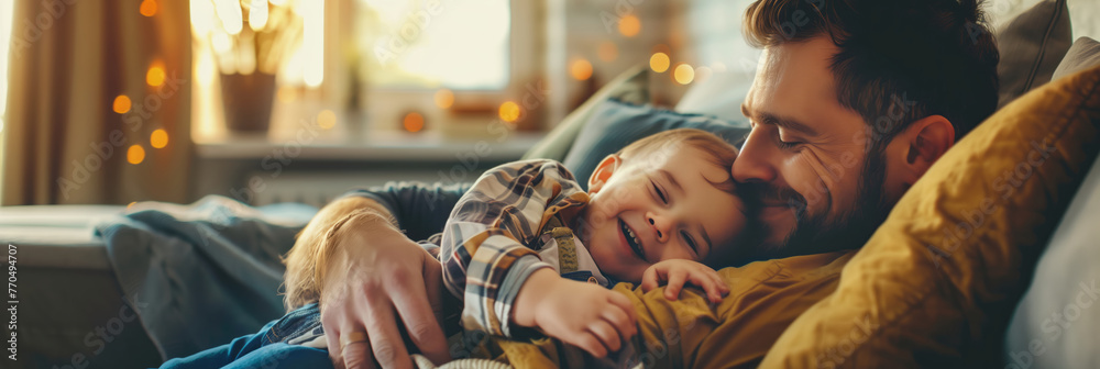 Portrait of loving father and his little son in a living room. Dad ...