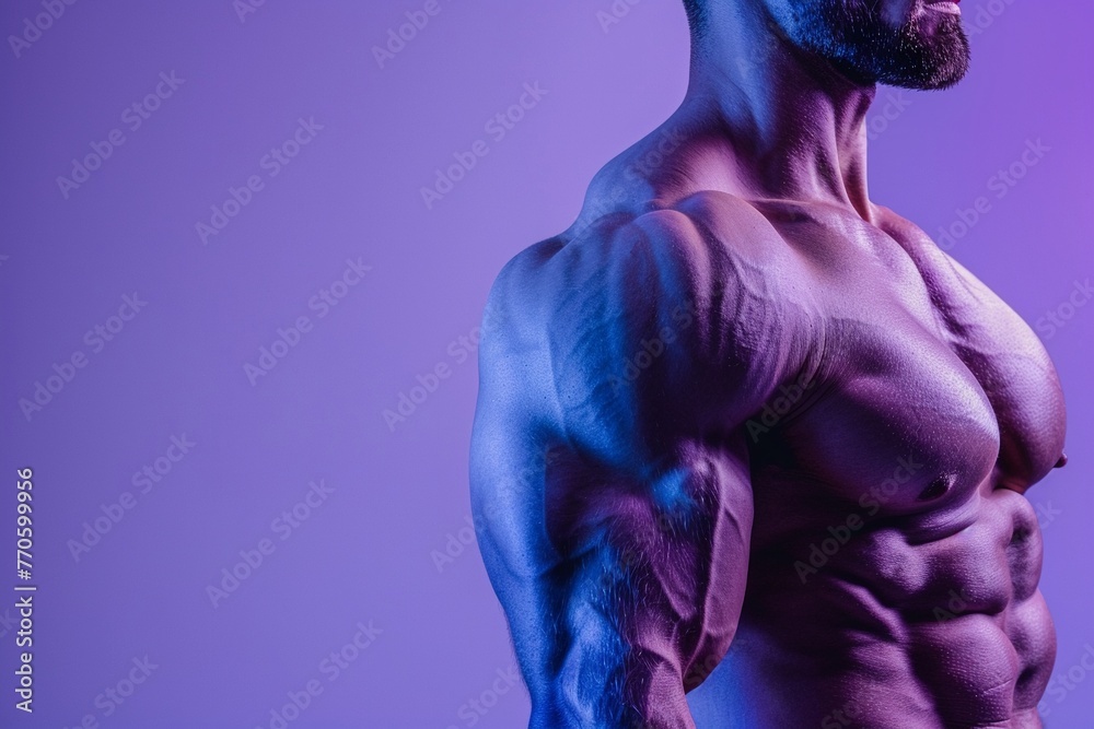 A muscular mans body with a focus on his highly defined arm muscles ...